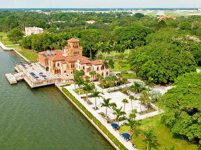 From above, the estate sprawls along the waterfront like a Mediterranean dream that somehow found its way to the Gulf Coast.