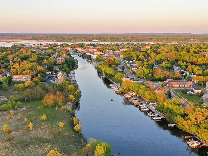 Autumn paints Manistee in golden hues as the river winds through town, connecting forest, community, and the vast blue of Lake Michigan.