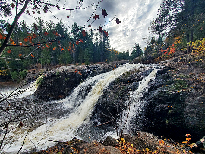 Autumn colors frame the cascading water, creating a scene so picturesque it almost seems too perfect to be real.