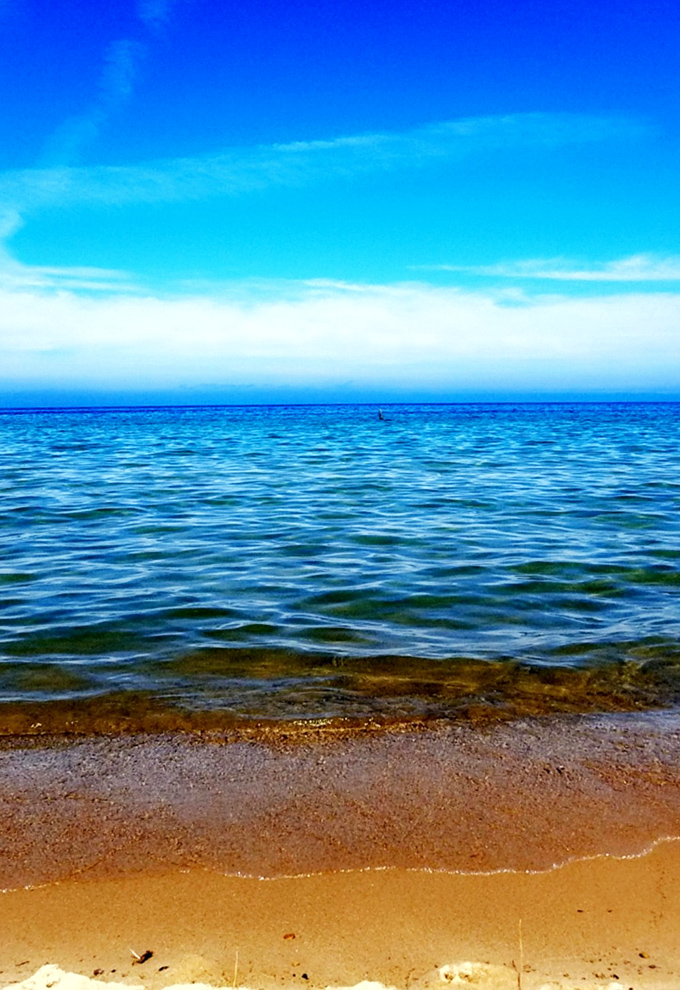 Heaven meets earth at Good Harbor Bay, where the sky's perfect blue melts seamlessly into waters equally determined to outdo it.