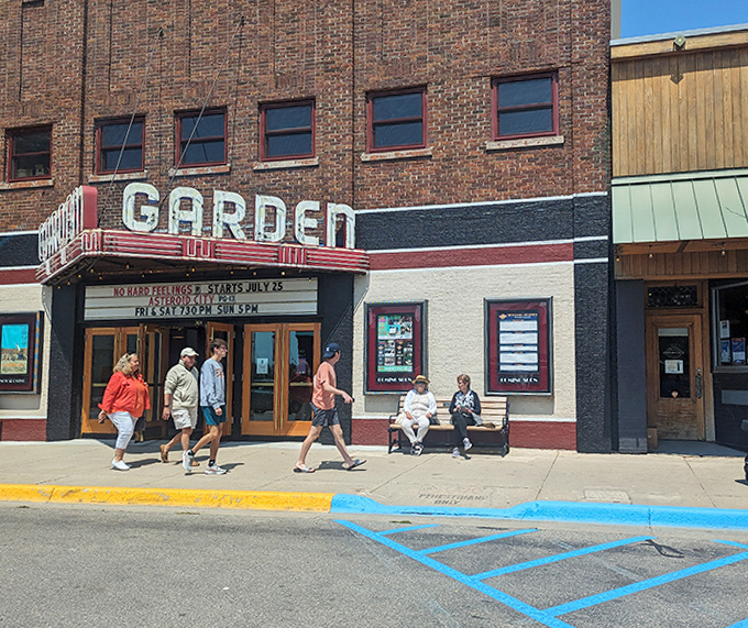 Summer visitors stroll past the marquee, some perhaps not realizing they're passing by one of Michigan's most charming cinematic treasures.