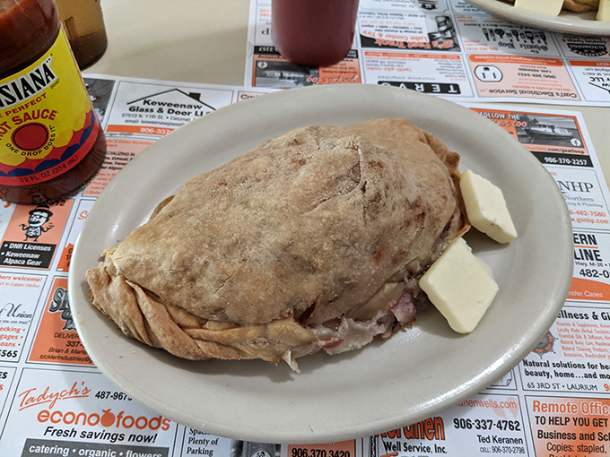 The massive calzone arrives golden and stuffed, because apparently Toni's Country Kitchen decided that regular portion sizes were just a suggestion to ignore.