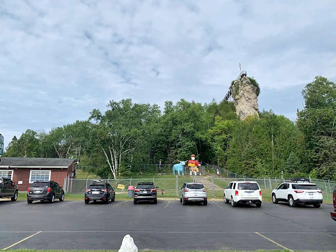 The parking lot fills with adventure-seekers' vehicles, all pointed toward that limestone tower rising through the trees beyond.