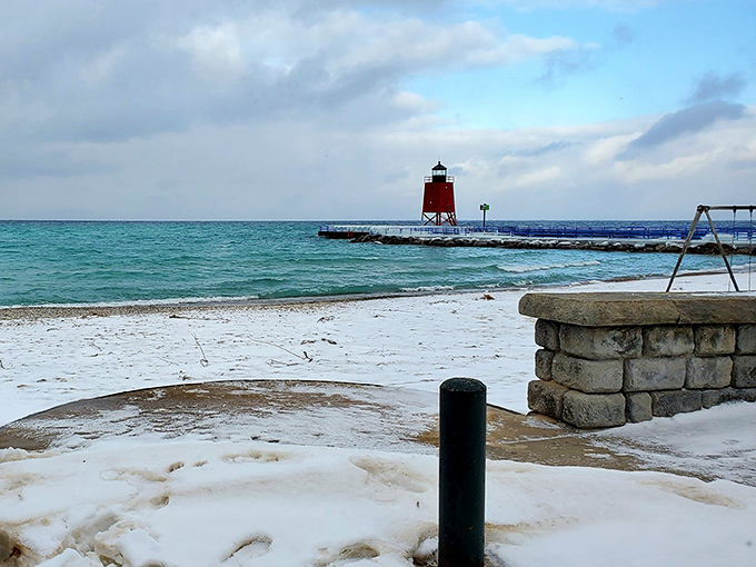 Winter's artistic touch transforms the South Pier Lighthouse into a snow-globe scene straight from a holiday card.