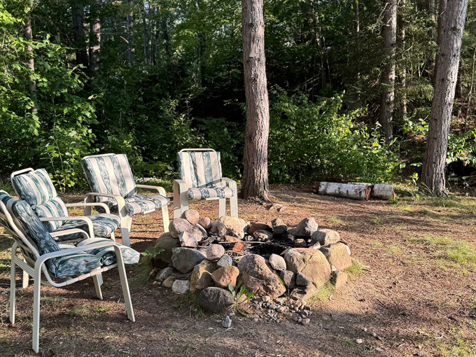A rustic fire pit area provides the perfect spot for evening s'mores in the shadow of aviation history.