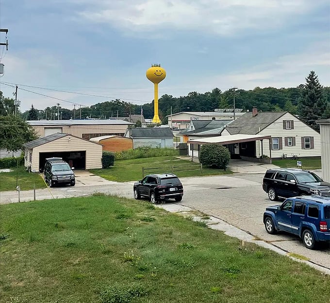 From neighborhood driveways, the tower peeks above rooftops, a friendly giant playing hide-and-seek with the community it serves.