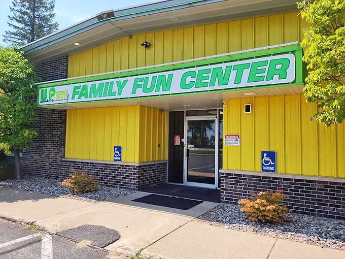 The cheerful yellow exterior of UPutt Family Fun Center belies the neon wonderland waiting inside – Escanaba's glowing gem.