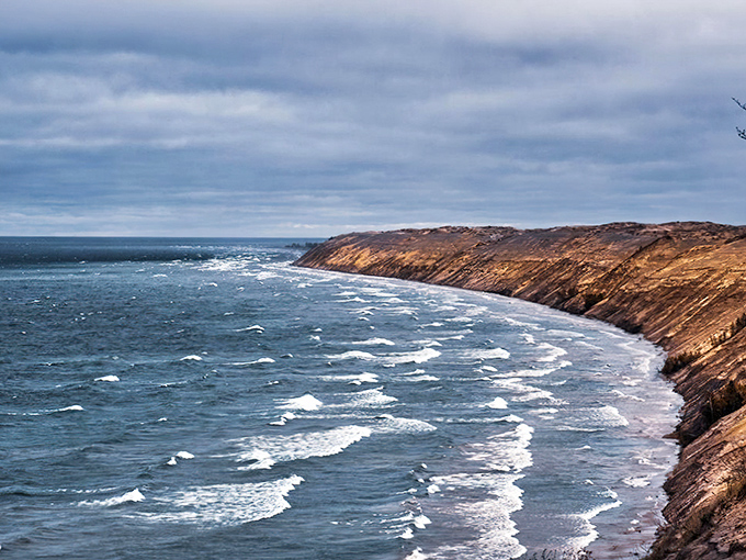 Dramatic cliffs meet churning waters in a powerful display of Lake Superior's might along the Grand Sable coastline.