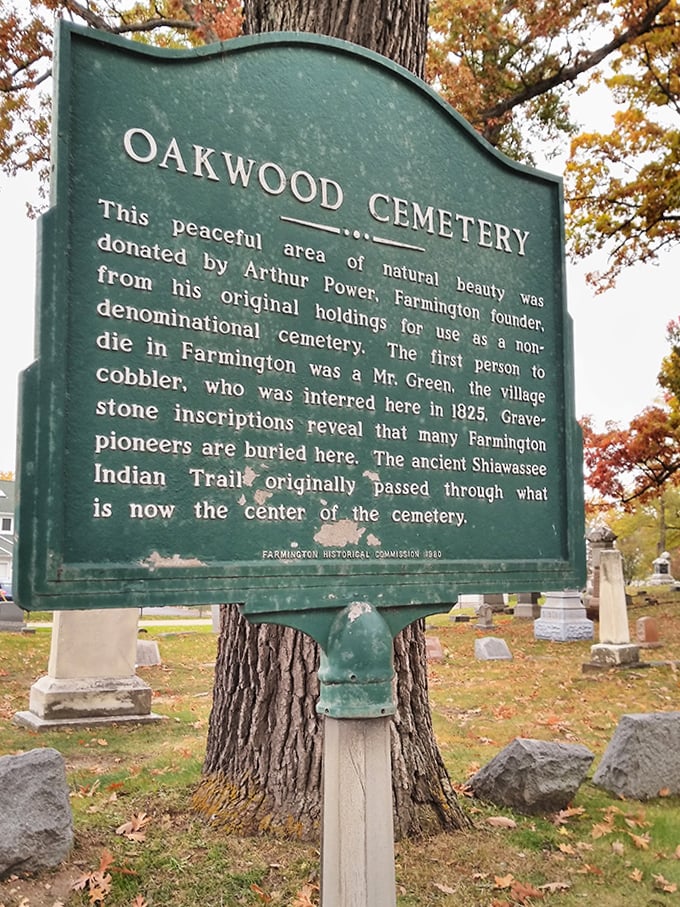 This green historical marker reveals Oakwood's origins as land donated by Farmington's founder, where even an ancient Indian trail once passed.