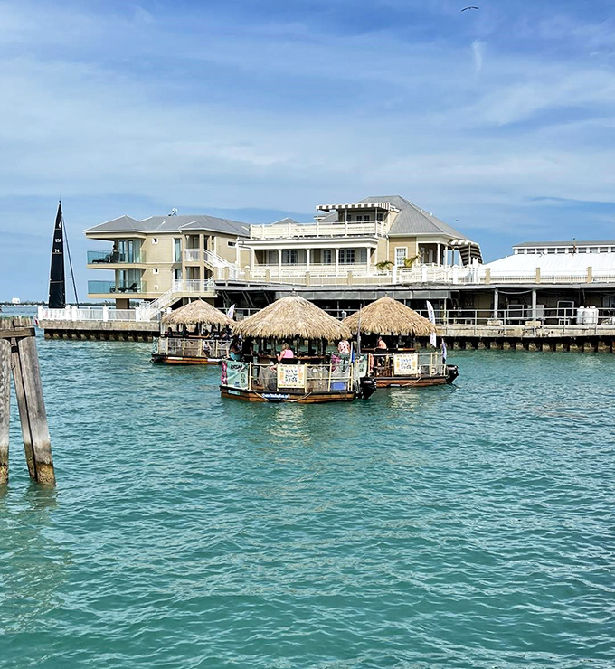 Docked and ready for departure, these floating tiki bars await their next group of adventurers against the backdrop of Key West's harbor.