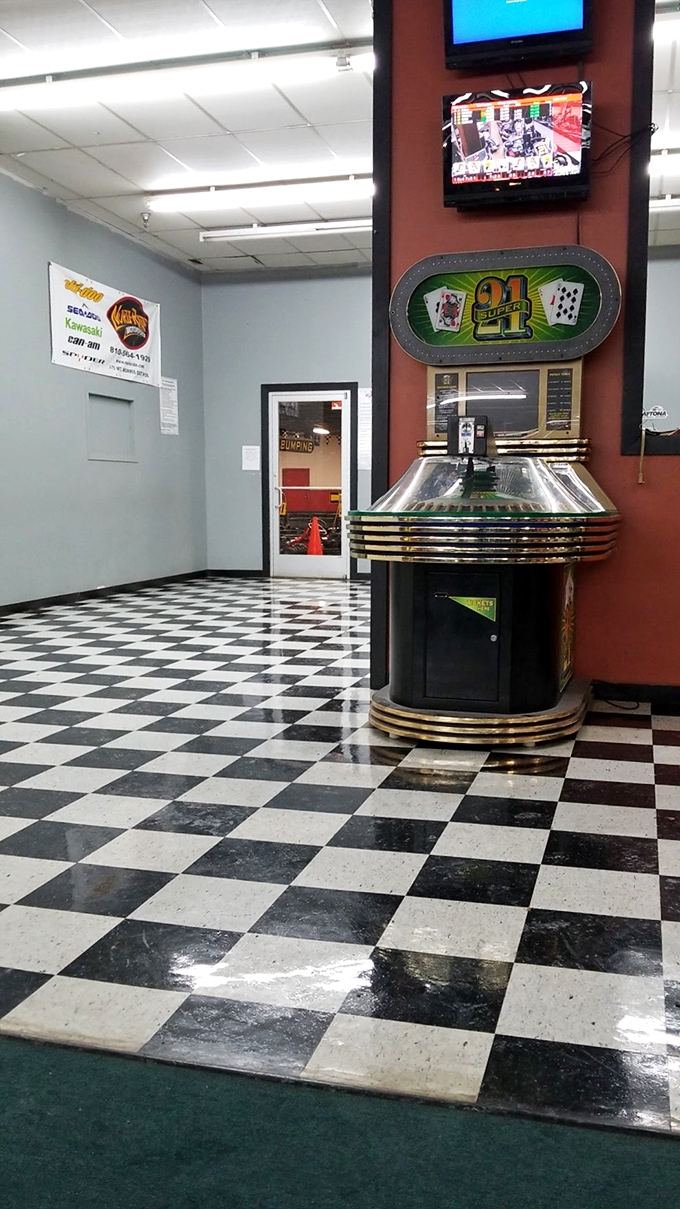 The classic black and white checkered flooring reinforces the racing theme throughout the facility's common areas.