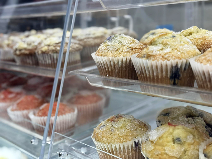 Muffin tops glistening with that perfect bakery sheen, promising moist interiors and flavors that'll make breakfast worth waking up for.