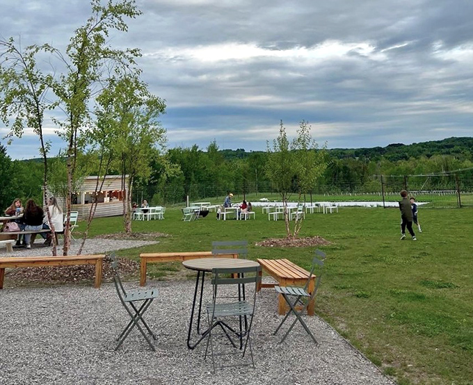Blue chairs dot the emerald lawn, inviting visitors to linger longer under Michigan's vast sky.