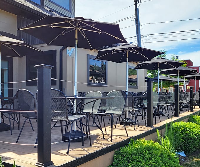 The outdoor patio offers prime people-watching opportunities under black umbrellas &ndash; perfect for contemplating life's important pickle questions.