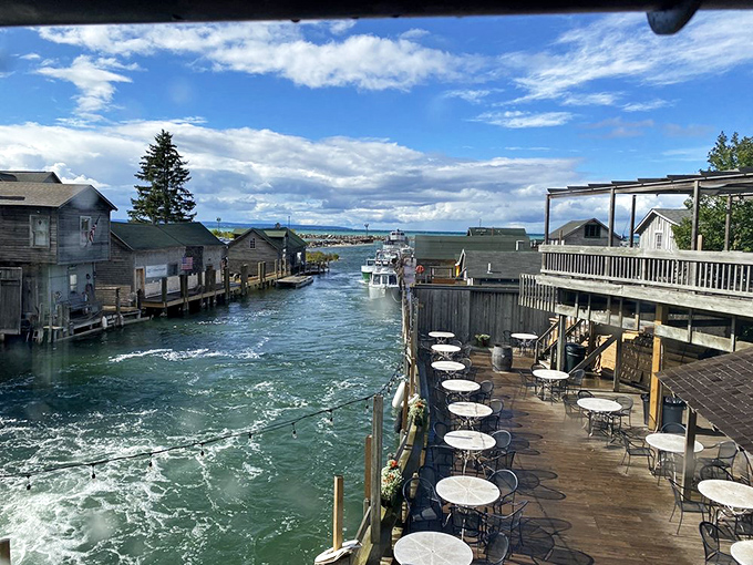 Waterside tables offer diners front-row seats to Leland's picturesque harbor views, where boats navigate the channel between weathered fishing shanties.