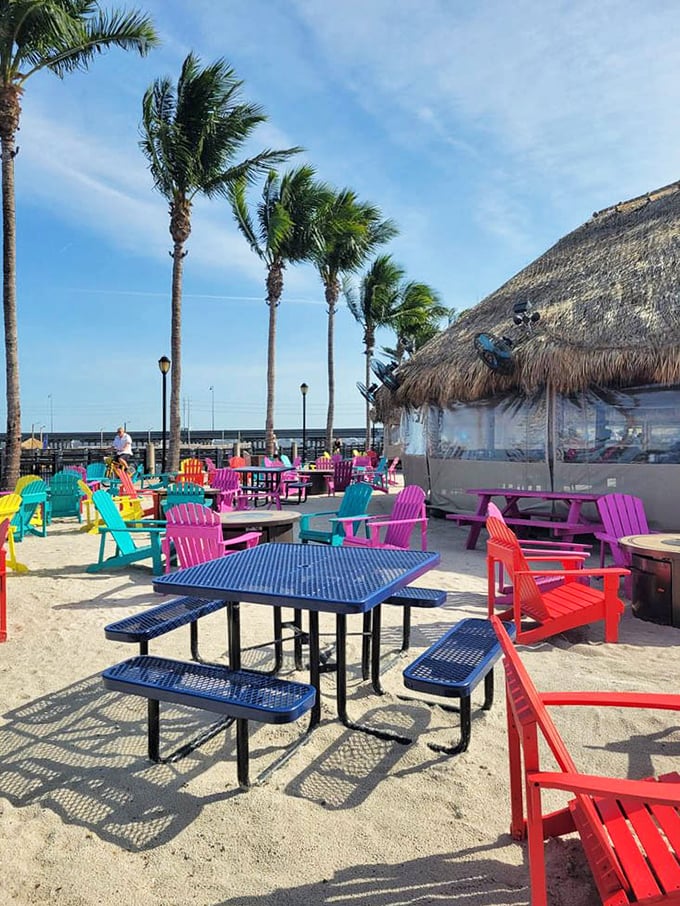 Colorful Adirondack chairs invite you to sink in and stay awhile. This sandy oasis proves Florida knows how to do outdoor seating right.