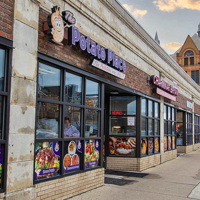 From another angle, The Potato Place's storefront beckons hungry passersby with colorful images of their most popular potato creations.