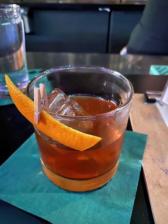 A perfectly balanced Old Fashioned gets the tropical treatment with orange peel and a clothespin that's equal parts quirky and clever.
