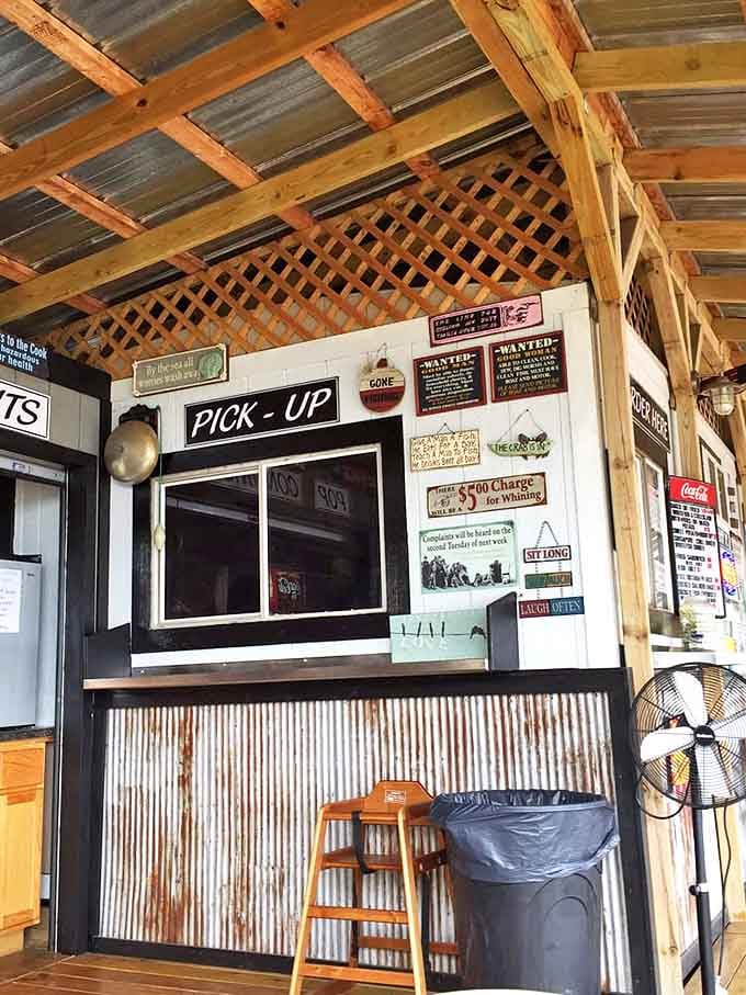 Where seafood magic happens &ndash; Peterson's efficient pick-up window, adorned with humorous signs, serves as the final gateway between hungry customers and fish perfection.