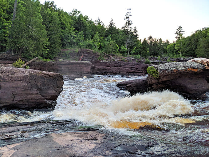 The river doesn't just flow – it tells stories! These rushing waters have been carving their narrative into ancient stone for millennia.