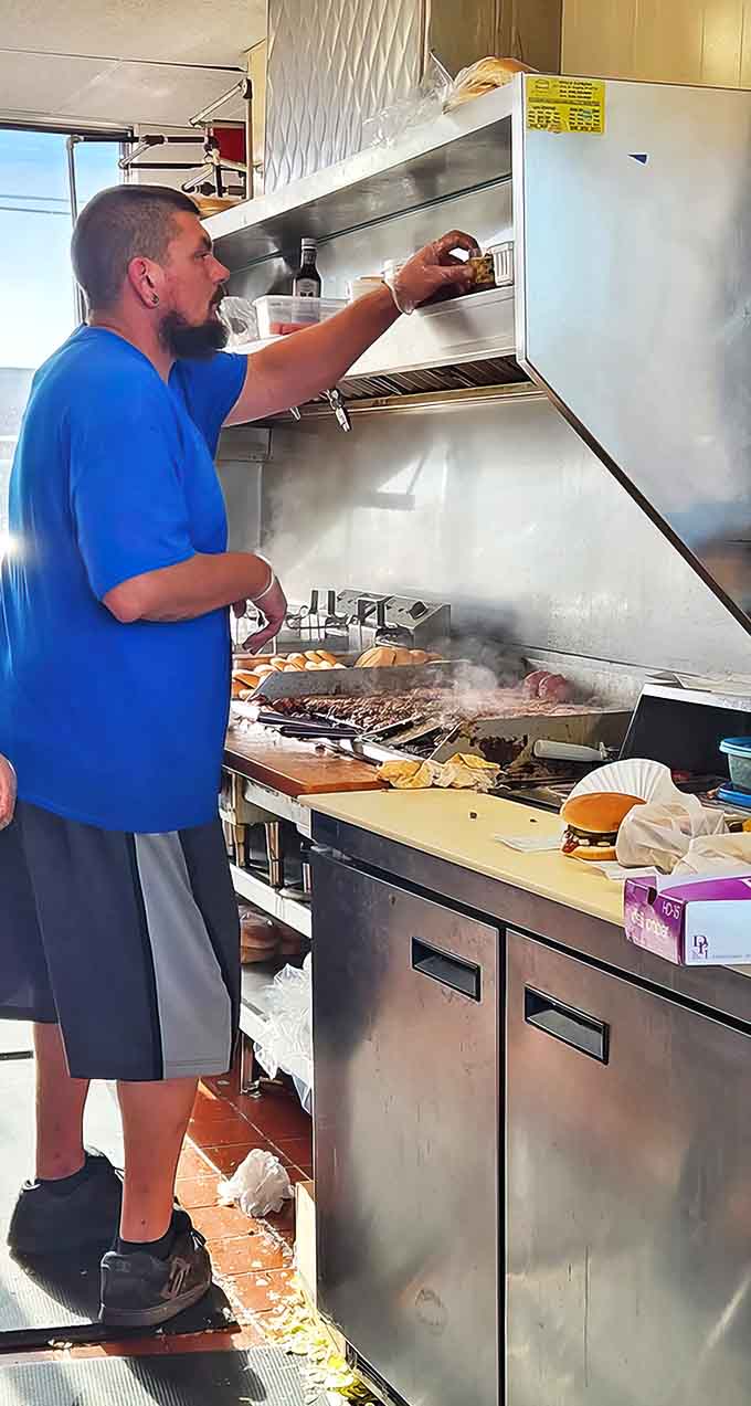 Prep station: Where the magic happens &ndash; skilled hands transform simple ingredients into legendary meals on Clyde's well-seasoned grill, a culinary performance art.