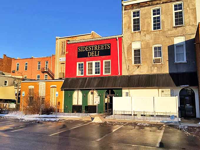 Sidestreets Deli's vibrant red facade stands out like an exclamation point downtown, promising sandwiches that require both hands and a strategy.