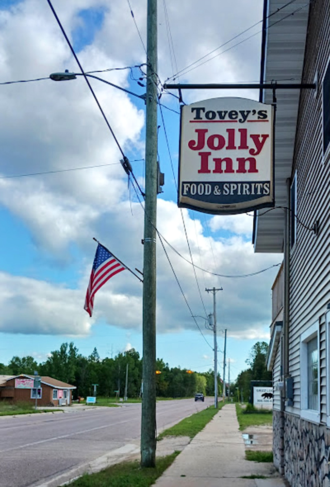The iconic Jolly Inn sign stands as a beacon for hungry travelers, promising hearty meals and warm welcomes in Michigan's Upper Peninsula.