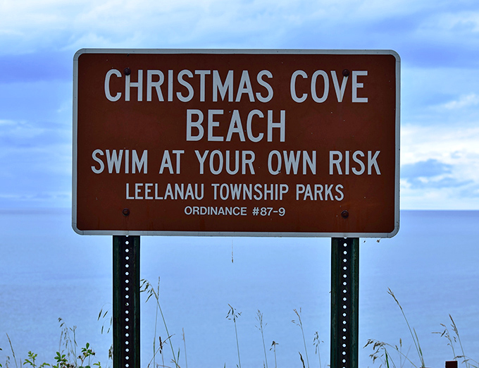 This iconic brown sign marks the entrance to Christmas Cove Beach, a beautiful lakeside destination within the Leelanau Township Parks.