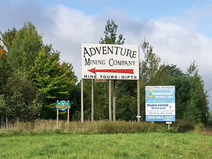 The unassuming roadside sign that marks the spot where ordinary day-trippers transform into underground adventurers.