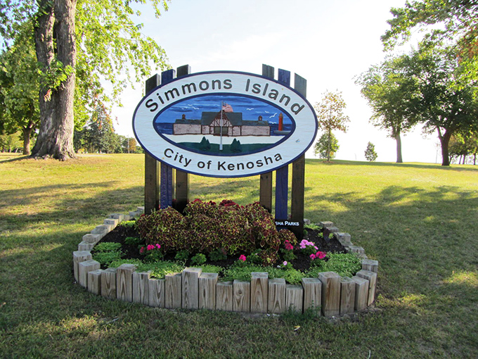 The welcoming Simmons Island sign greets visitors to this lakefront gem, where Wisconsin proves it can compete with coastal beach destinations.