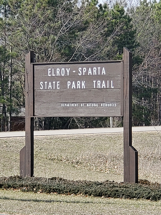 The official trail sign marks the beginning of an adventure that connects small towns, tunnels, and cyclists from around the world.