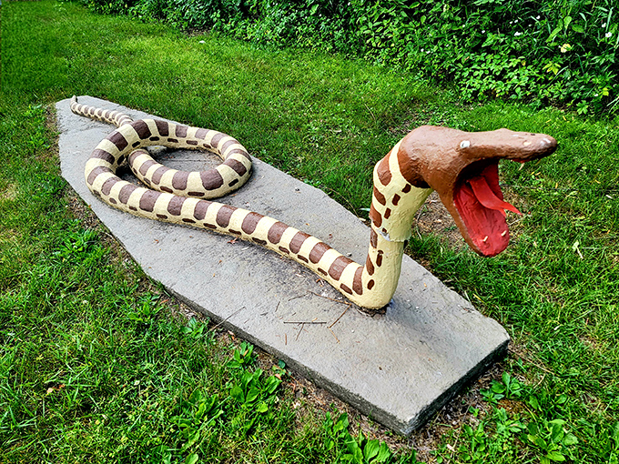 This concrete serpent, mouth agape and ready to strike, adds a touch of playful danger to the otherwise peaceful sculpture garden.