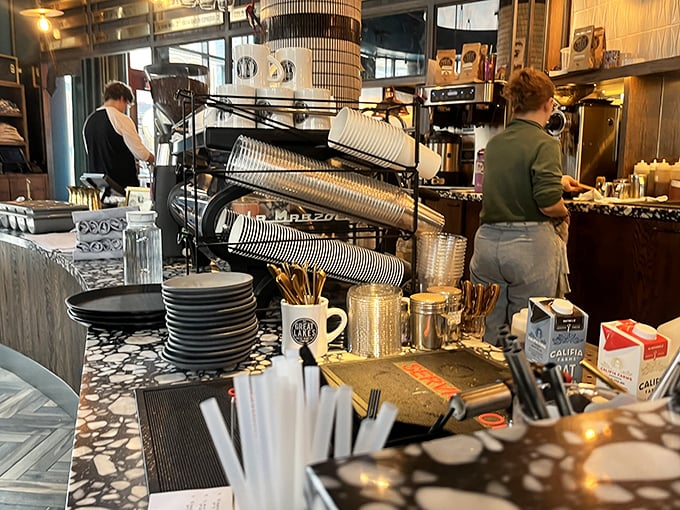 Behind the counter, skilled staff orchestrate the morning rush with practiced precision, turning coffee beans into liquid gold.