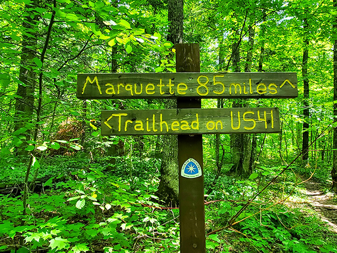 "Marquette: 85 miles" &ndash; this weathered sign reminds hikers they're not just on any path, but part of an epic journey.