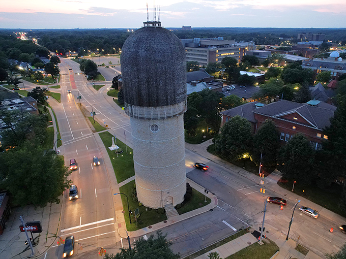 The water tower glows at dusk, standing sentinel over a town where history and modernity dance together under Michigan skies.