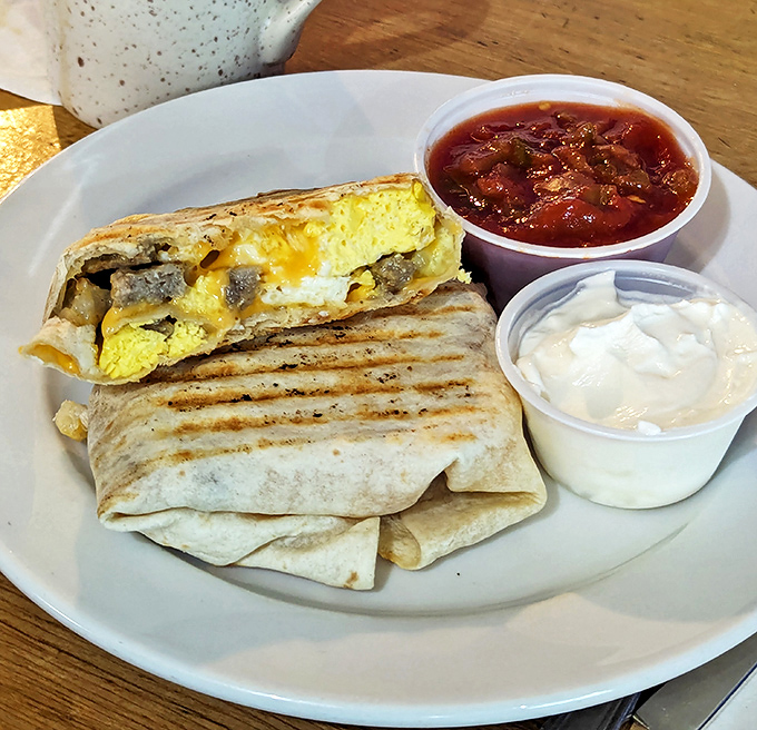 Breakfast burritos don't get better than this grilled perfection, served with sides of salsa and sour cream for customizable bites.