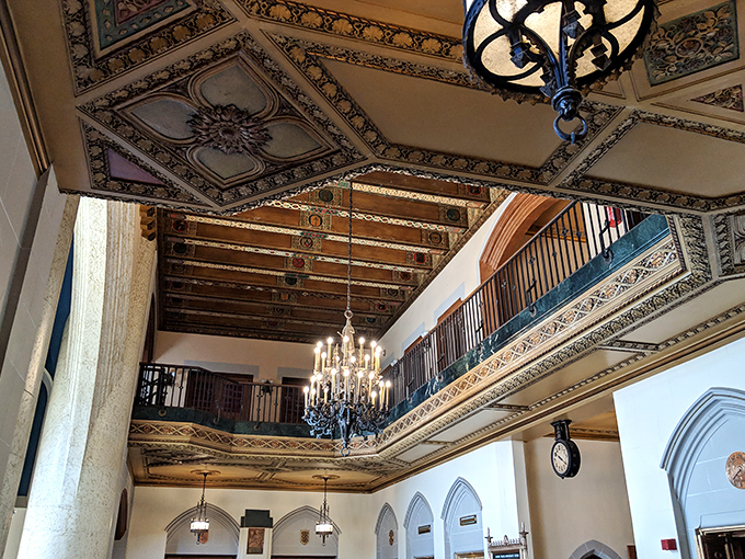 Ornate chandeliers hang from intricately painted ceilings, illuminating a space where history and artistry merge in spectacular fashion.