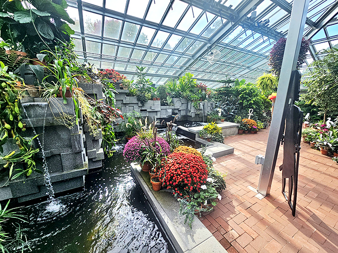 Indoor oasis: Tropical plants thrive year-round in this greenhouse sanctuary, where water features create a soothing soundtrack for plant admirers.