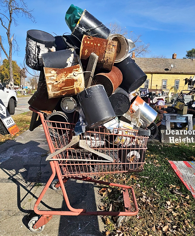 A shopping cart bears the weight of metal history, overflowing with pots and pans that once served Detroit's families.