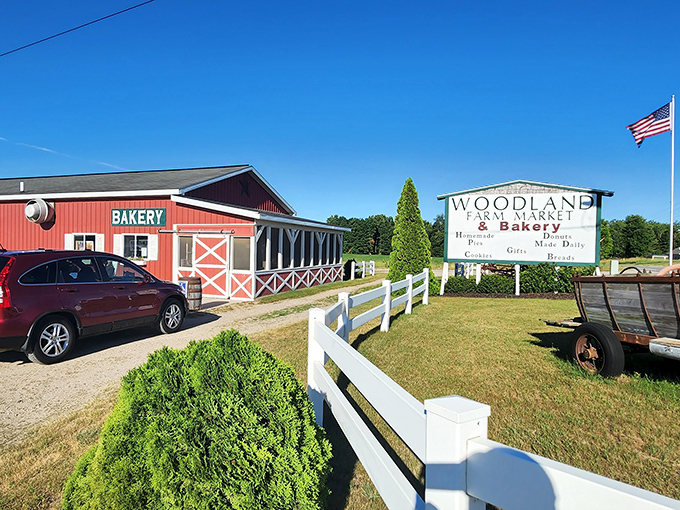 Sunshine highlights the classic farmhouse design &ndash; white fence, red barn, and the American flag completing this slice of Midwest heaven.