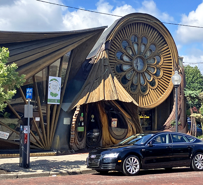 From the street, Chez Olga stands as a wooden sculpture among brick buildings &ndash; architectural rebellion in the heart of Grand Rapids.