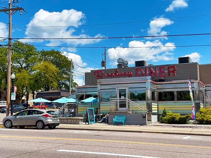 Outside View: The classic silhouette against blue skies promises authentic diner experiences inside that shining, striped aluminum exterior.