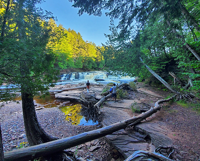 Explorers make their way toward nature's masterpiece, unaware they're about to become supporting characters in their own adventure story.