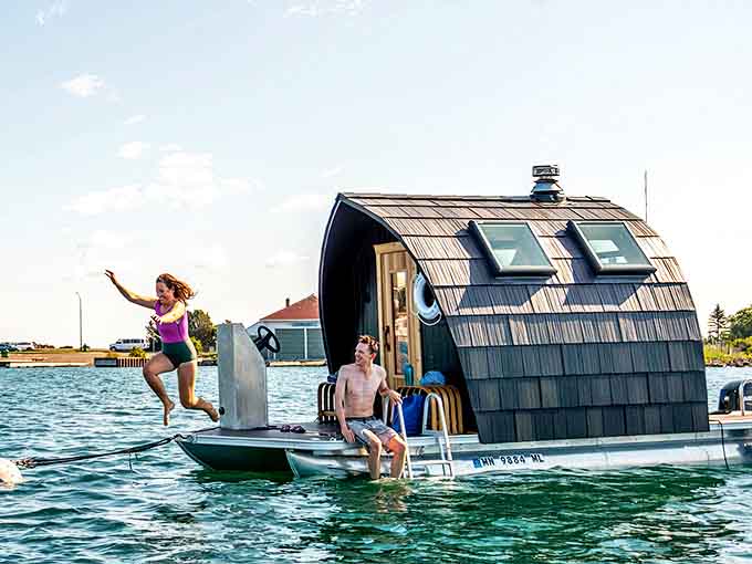 The ultimate sauna finale: pure joy captured mid-air as cool lake waters await, completing the ancient hot-cold ritual with a splash.
