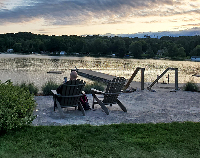 As day fades to dusk, Adirondack chairs become front-row seats to nature's nightly masterpiece – a Michigan sunset that no smartphone camera can truly capture.