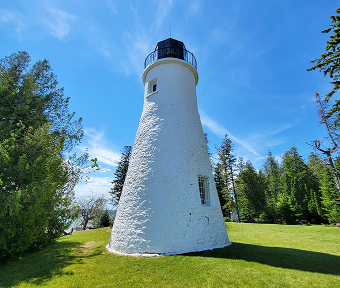 The lighthouse stands proudly against Michigan's summer sky, its whitewashed walls practically glowing in the sunshine.