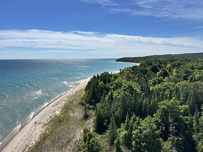 Scenic view from the lighthouse: Nature's perfect panorama&mdash;golden beaches, emerald forests, and sapphire waters combine in Michigan's most photogenic vista.
