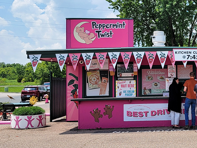 The Peppermint Twist signage stands proud against Minnesota blue skies, a pink landmark that's been making summers sweeter for generations.