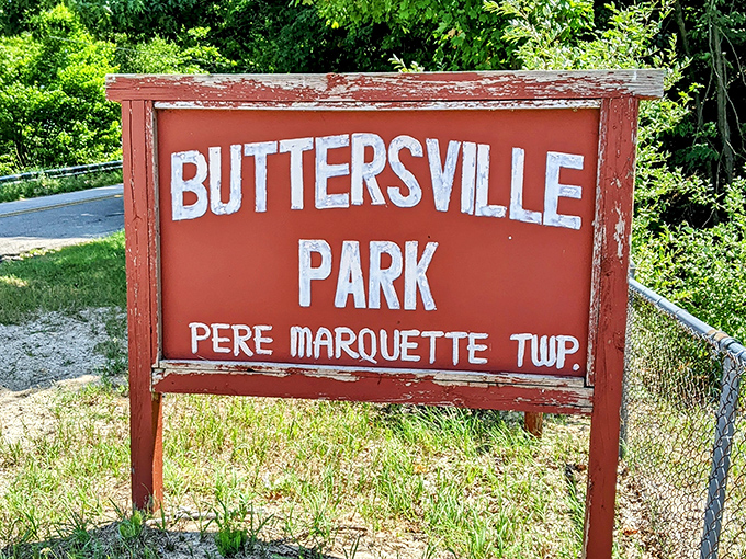 The weathered park sign stands as a humble introduction to one of Michigan's most spectacular natural treasures.