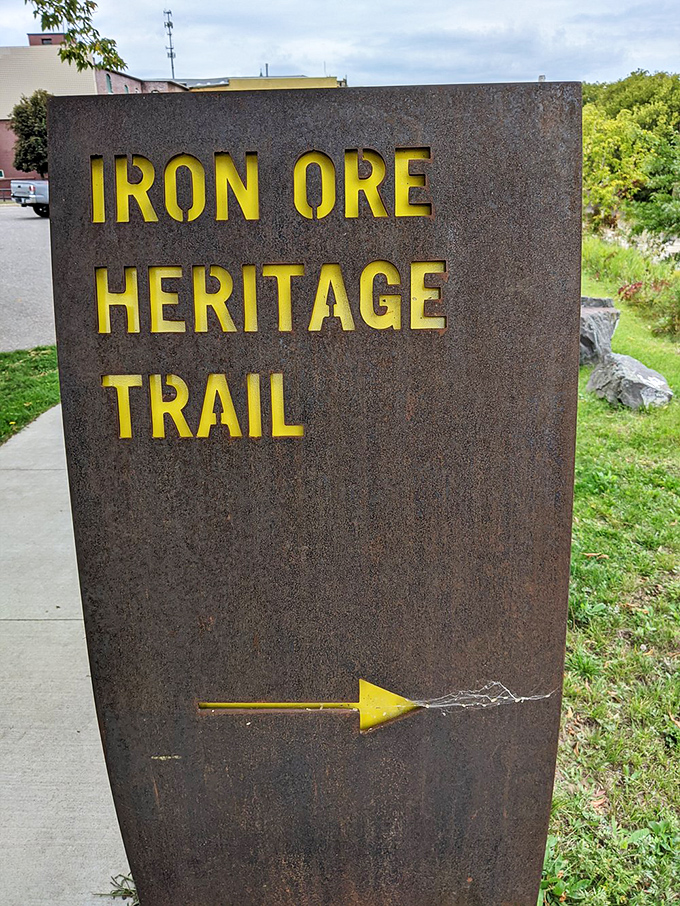 This weathered trail marker points the way forward, its rusty patina a perfect metaphor for the journey through Michigan's iron-rich history.